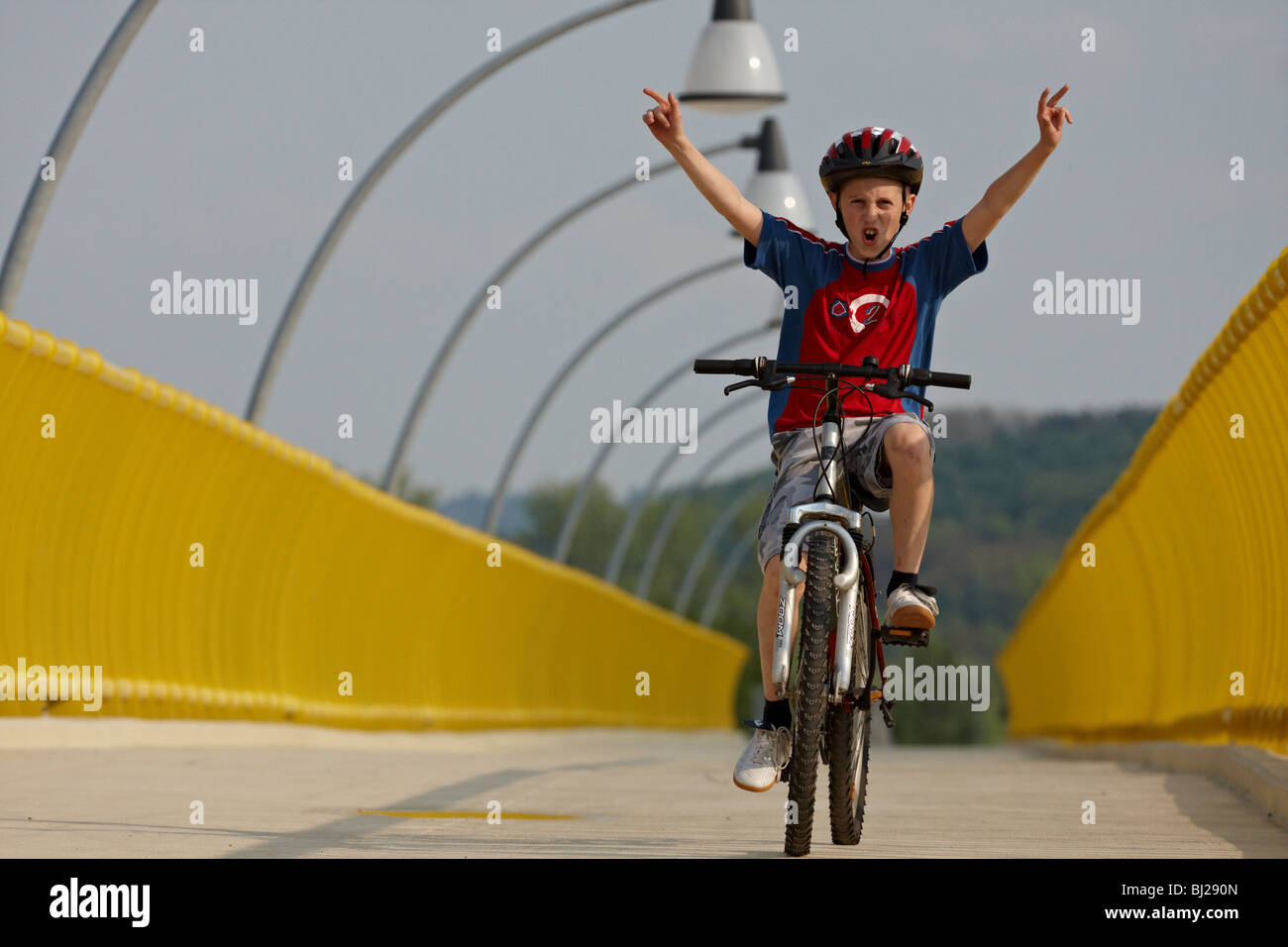 boy riding a bicycle on the bridge Stock Photo - Alamy