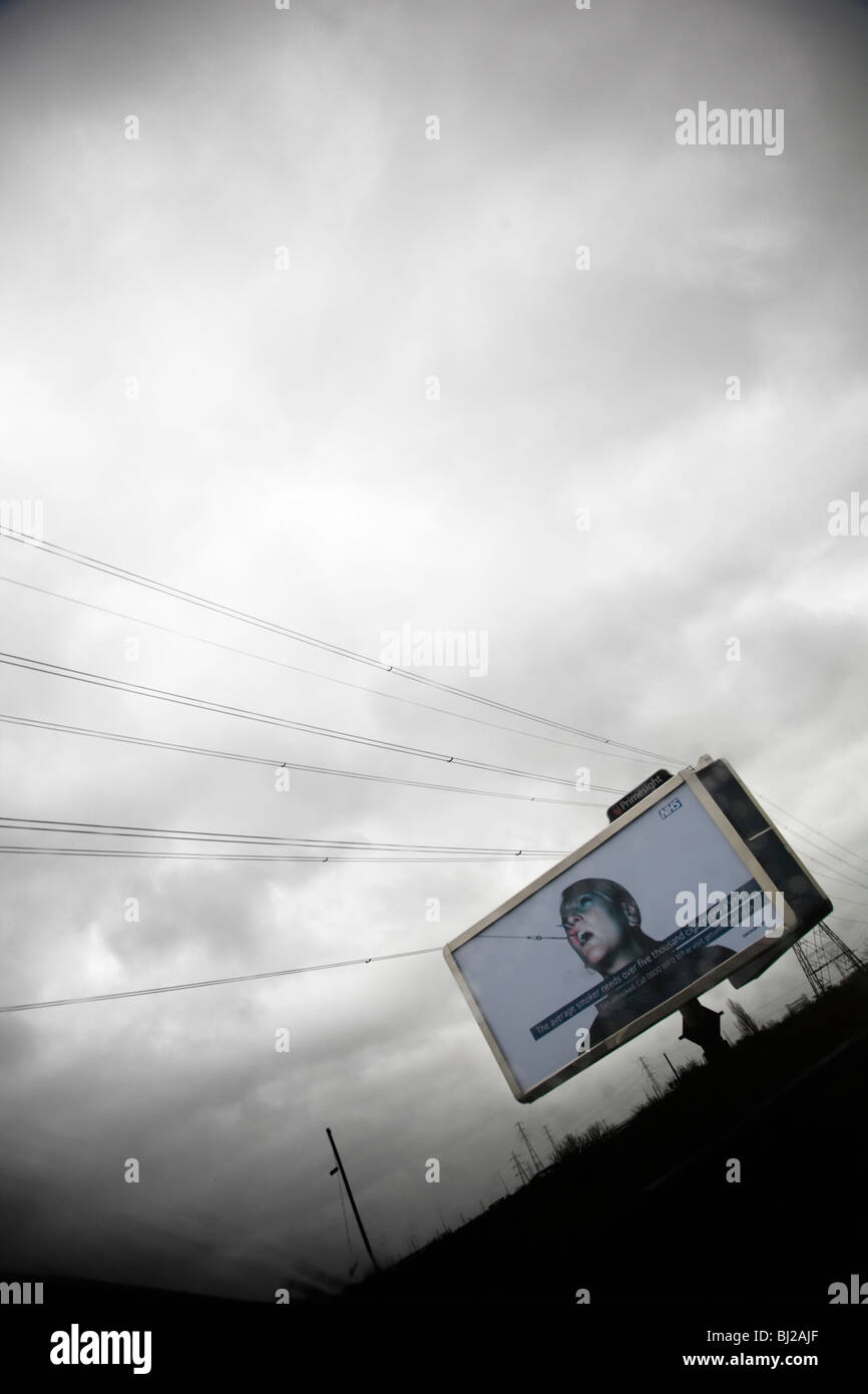 billboard and pylons seen from the A406 north circular road East London ...
