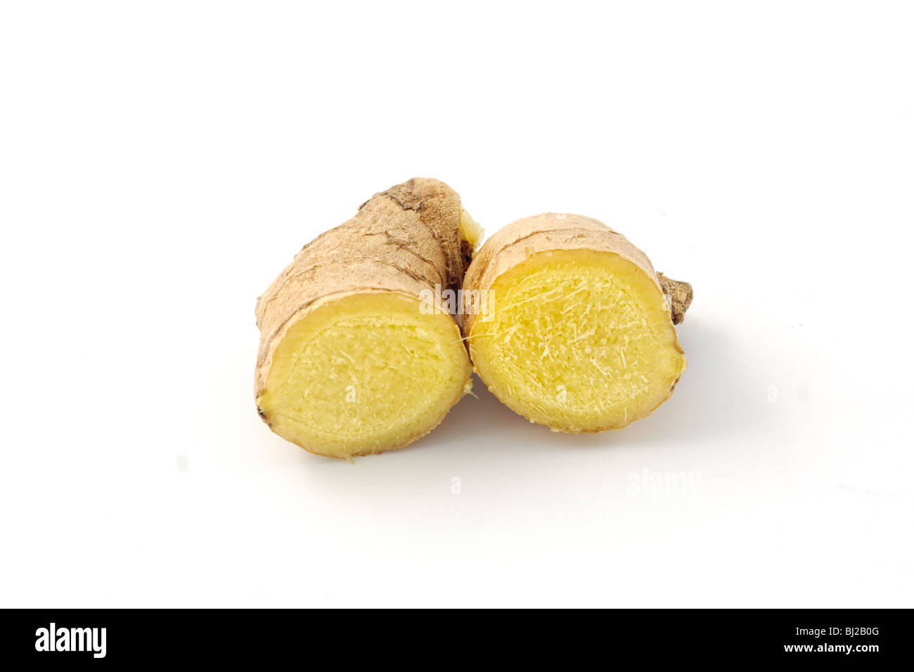 Cut root ginger isolated on white Stock Photo - Alamy