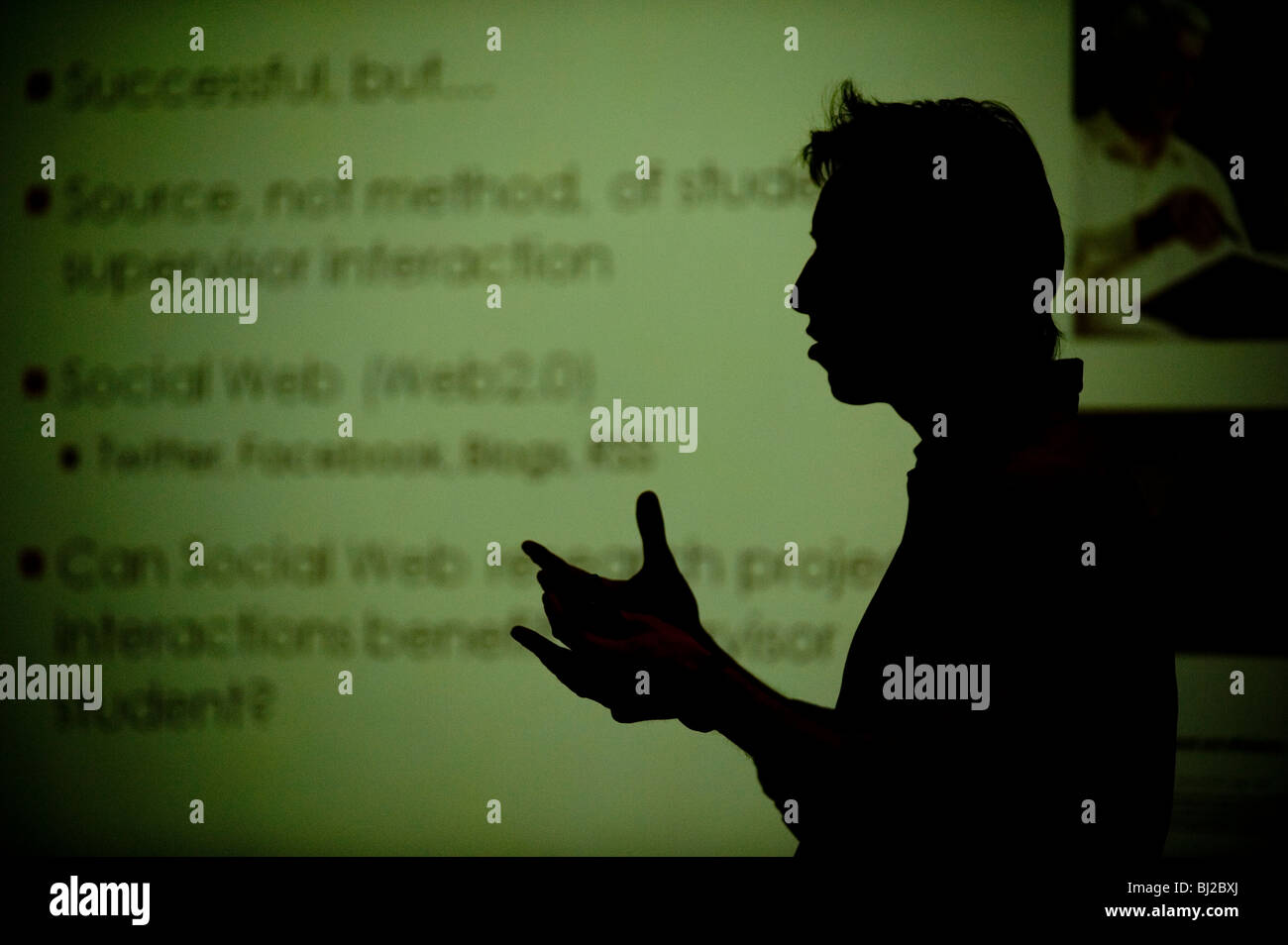 A lecturer talks to students using hand gestures Stock Photo - Alamy