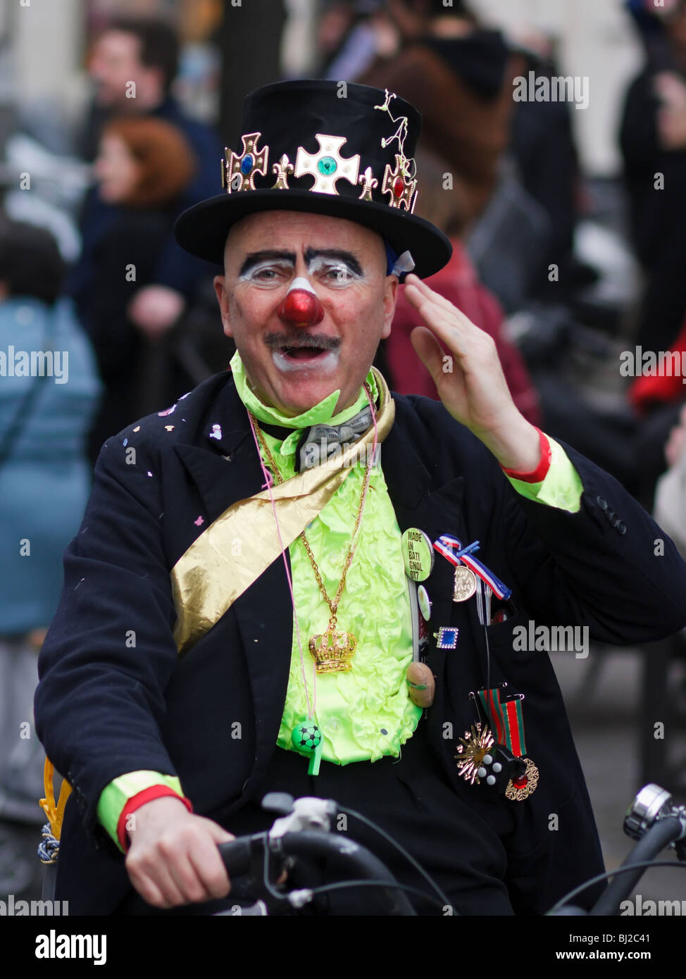 A man in a clown costume performing at the carnival parade in the ...