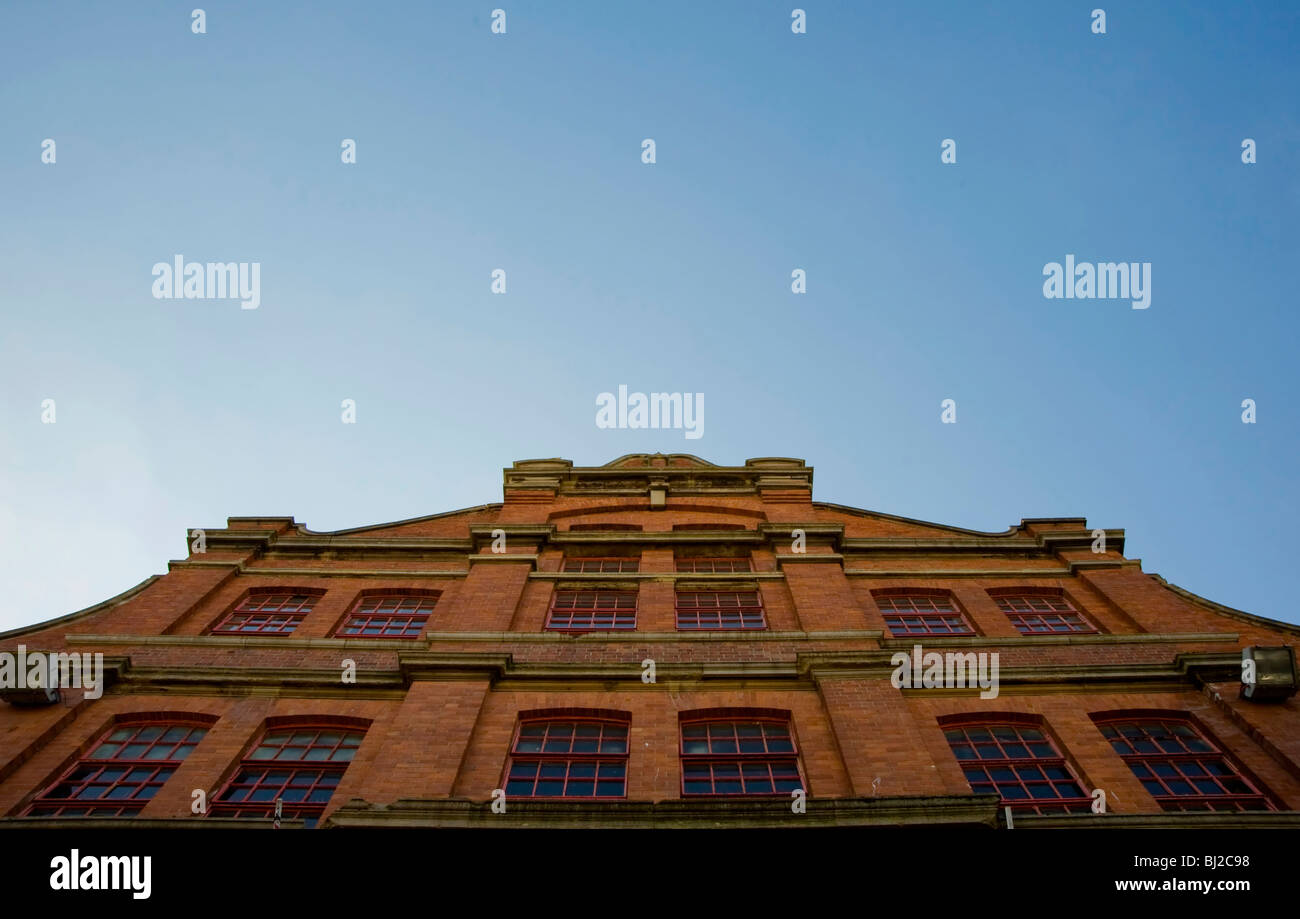 Red brick building receding perspective into blue sky Stock Photo - Alamy
