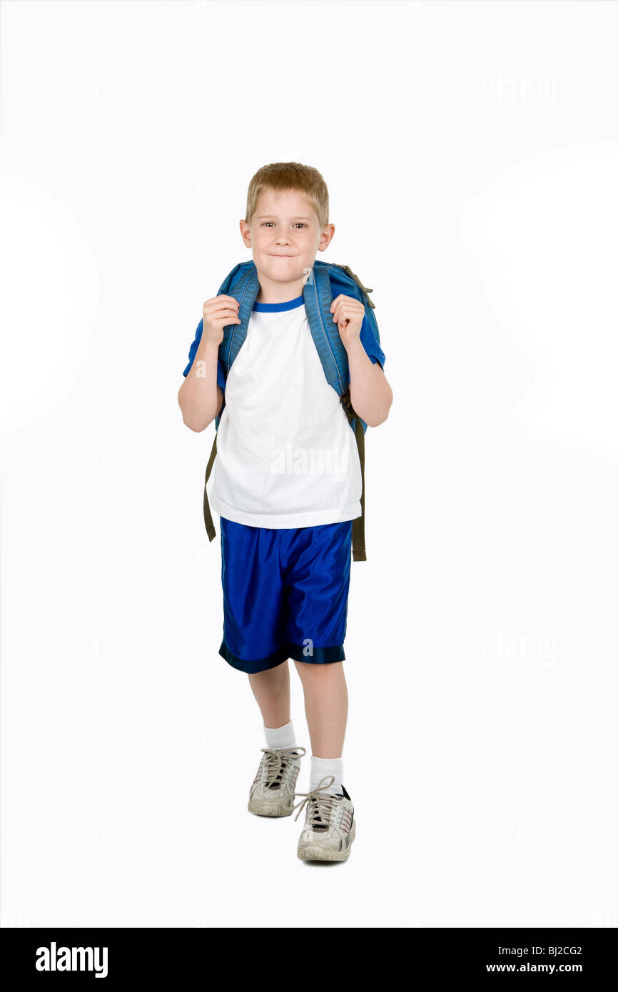 A happy child with a backpack walks towards the camera Stock Photo - Alamy