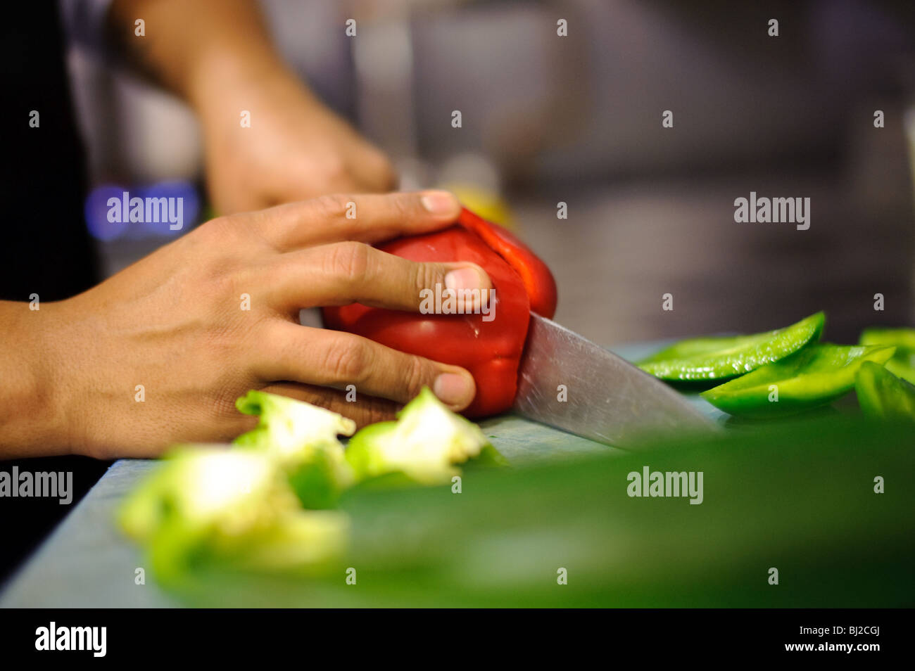 Food preparation in a restaurant - chopping fresh seasonal vegetables ...