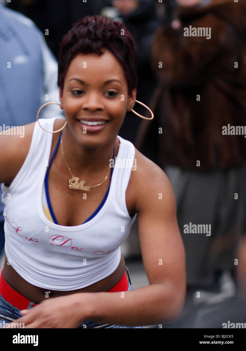 Female dancer performing at the carnival parade in the streets of Paris ...