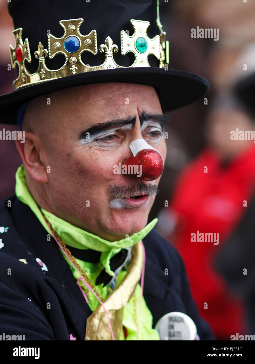A man in a clown costume performing at the carnival parade in the ...
