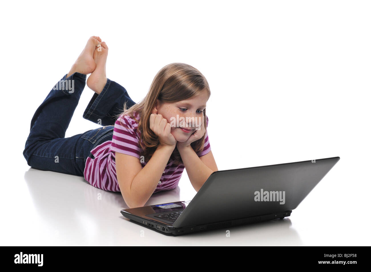 Little girl with laptop computer isolated on a white background Stock ...
