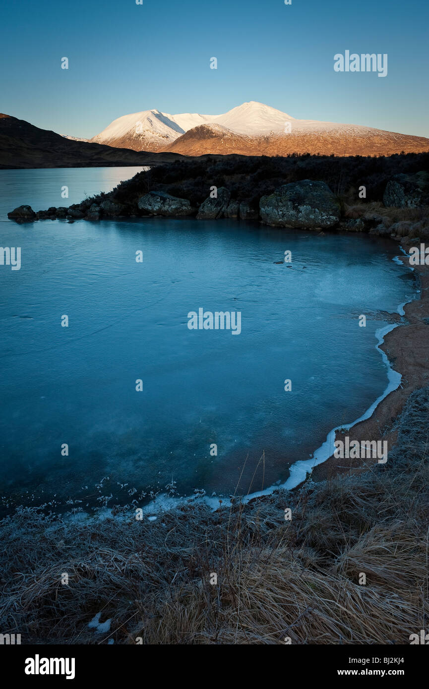 Thick ice on the shore of a wee beach at Lochan na h-Achlaise on ...