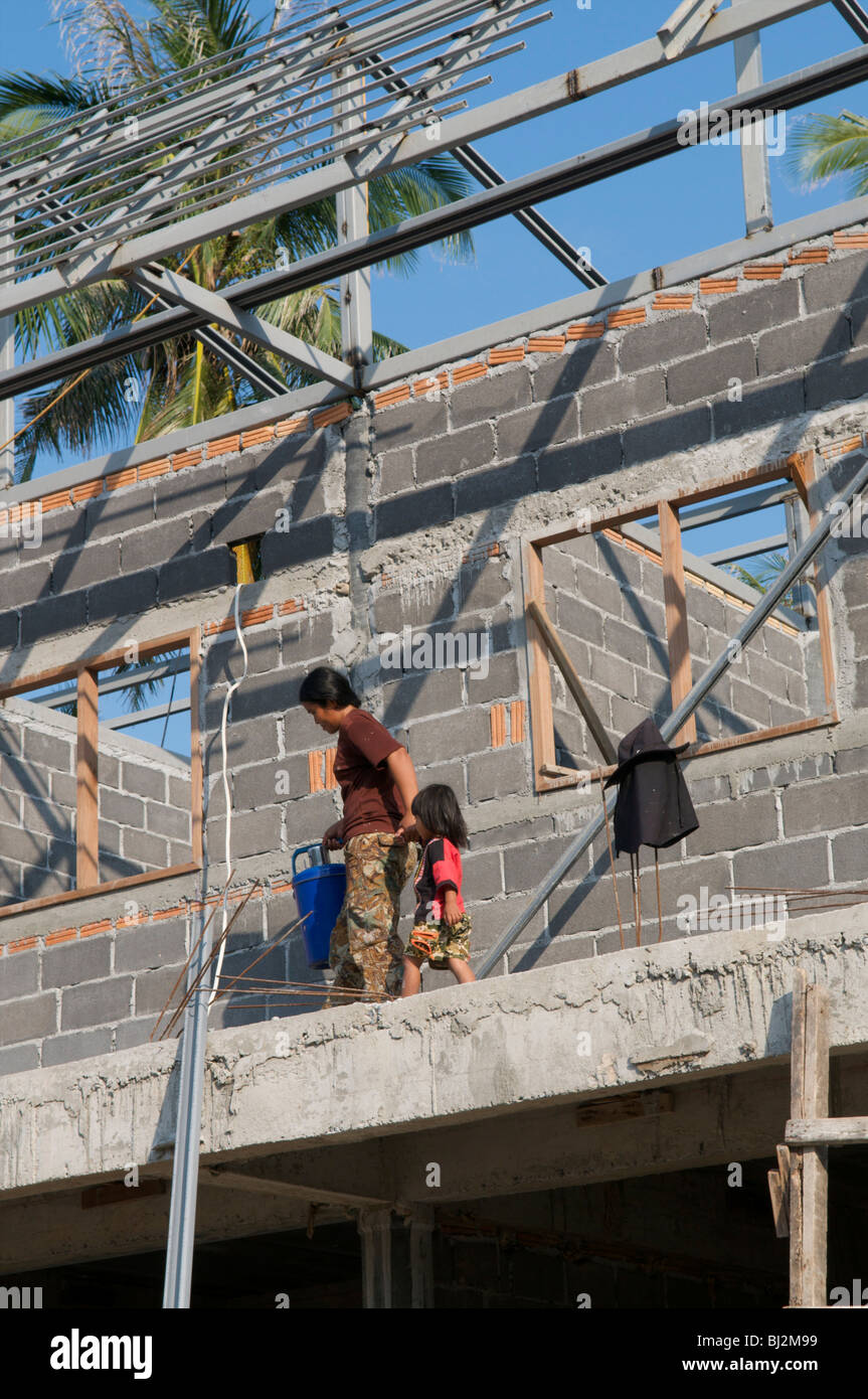 construction worker with her daughter on a building site in Thailand ...