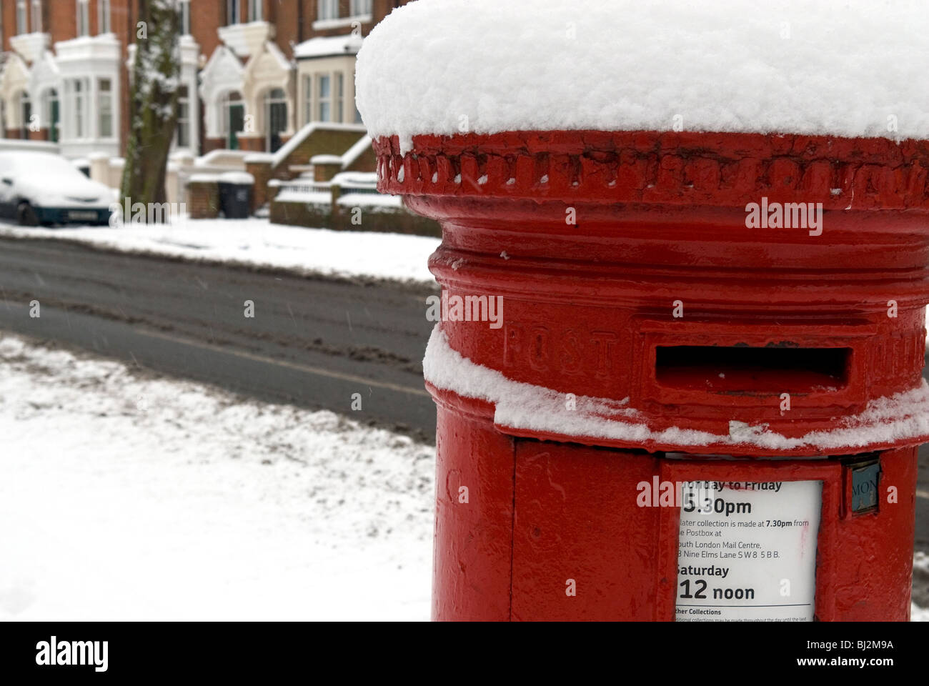Red letter box after heavy snowfalls in London Stock Photo - Alamy