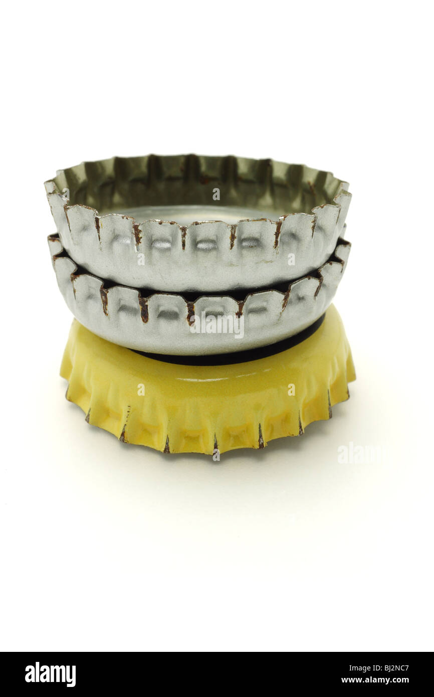 Stack of used bottle caps on white background Stock Photo - Alamy