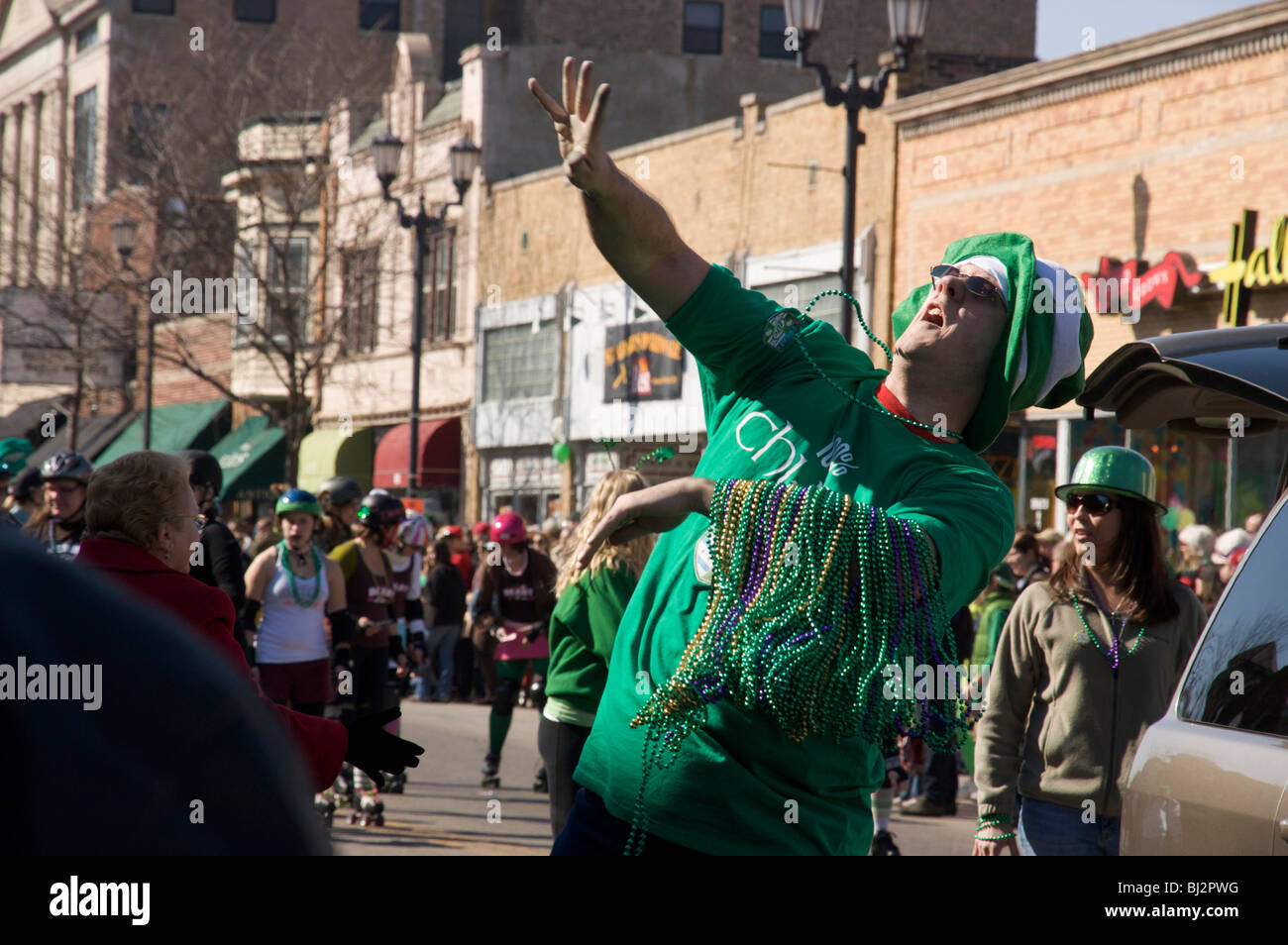 Parade participant throwing beads. 2010 St Patrick's Day Parade. Forest ...