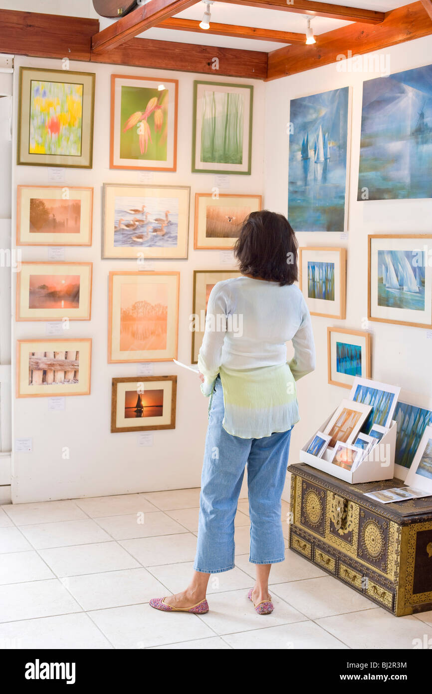Woman Viewing Artwork in Small Art Gallery Stock Photo - Alamy