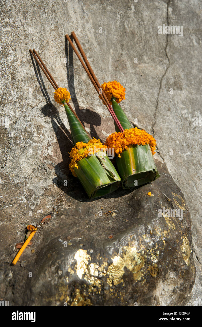 Banana leaf cones decorated with yellow chrysanthemum flowers and joss ...