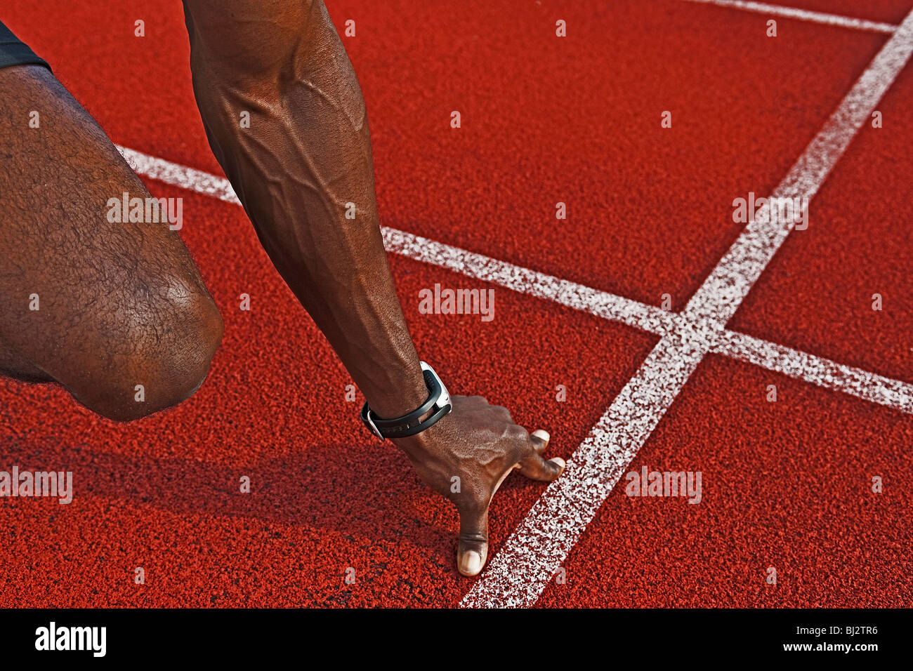 Sprinter's hand on start line Stock Photo - Alamy