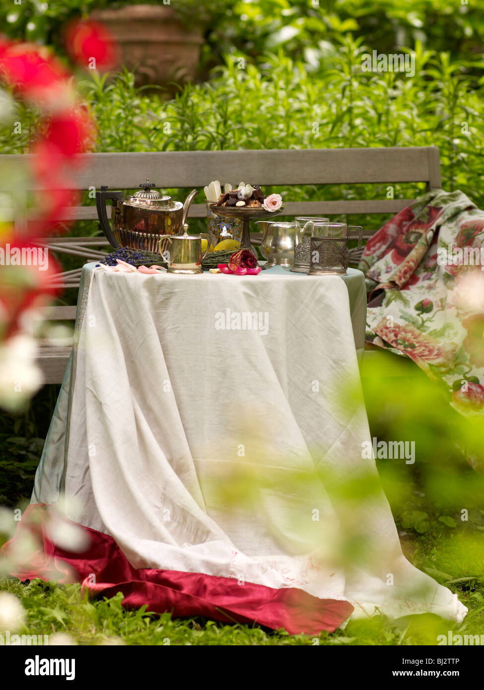 Coffee table in a romantic garden Stock Photo - Alamy