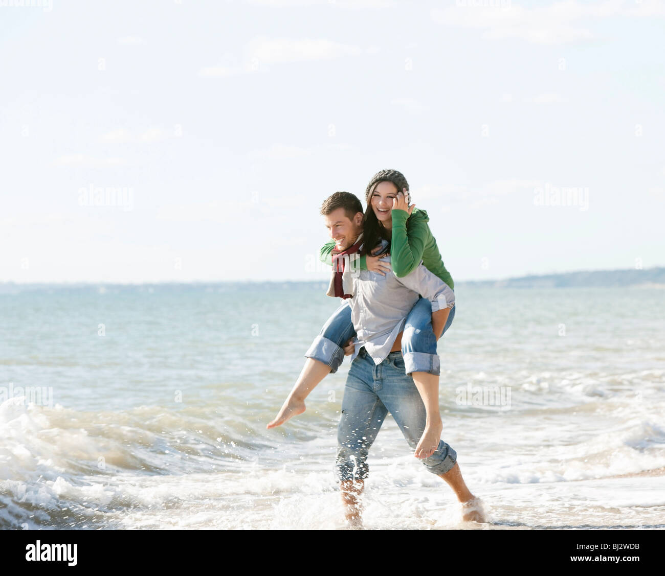 Woman riding piggyback by the sea Stock Photo - Alamy