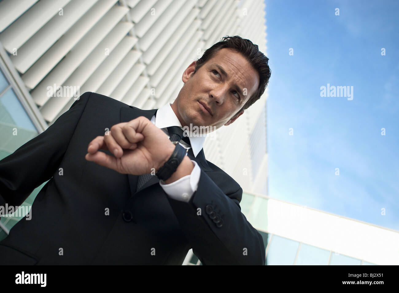 Businessman keeping time with watch Stock Photo - Alamy