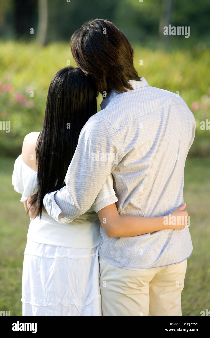 Rear view of young couple standing together Stock Photo - Alamy