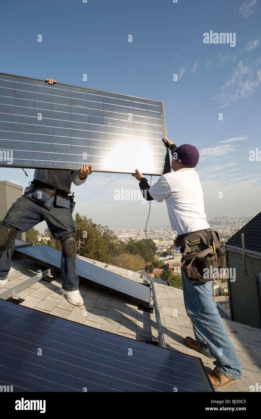 Group of people installing solar panels hi-res stock photography and ...
