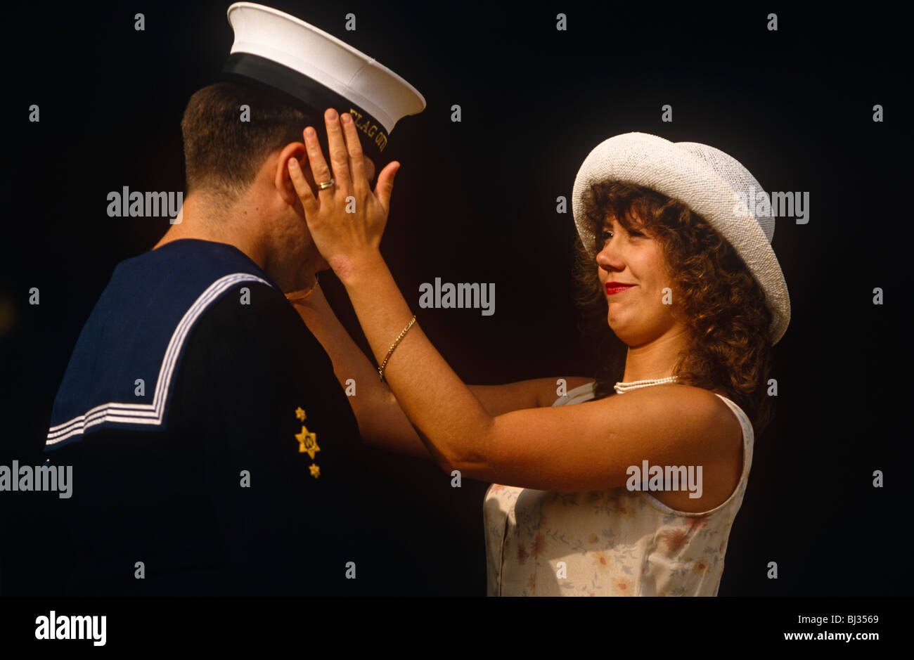 A devoted wife and her sailor husband ready themselves for a formal ...