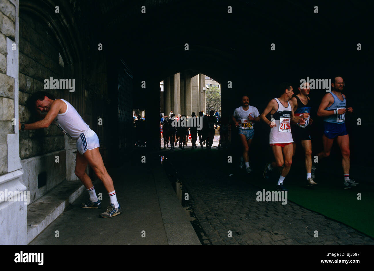 A few miles from the finish line, a marathon runner has stopped in ...