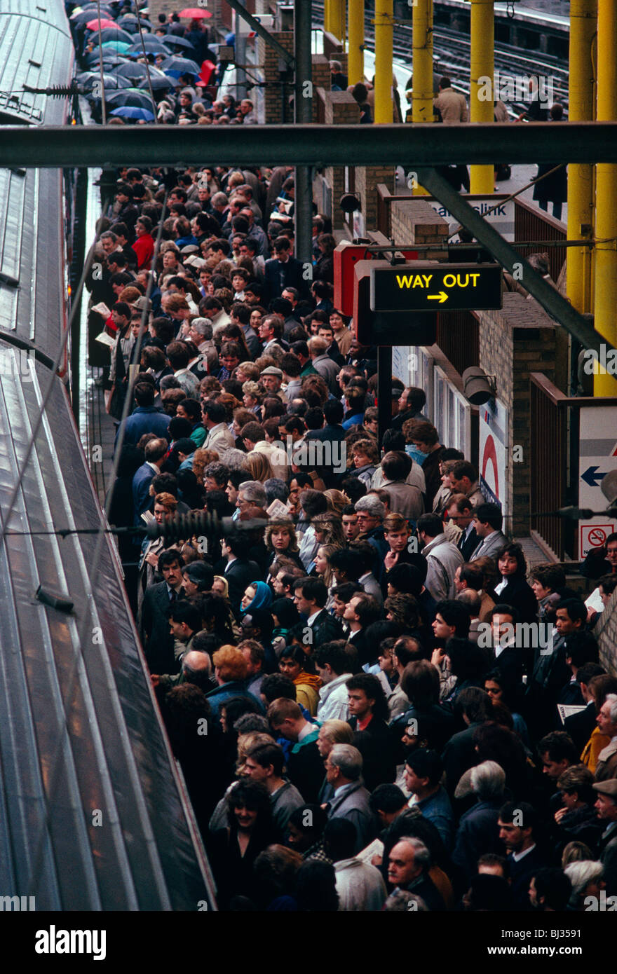 During the evening rush hour, hundreds of rail commuters are queuing to ...