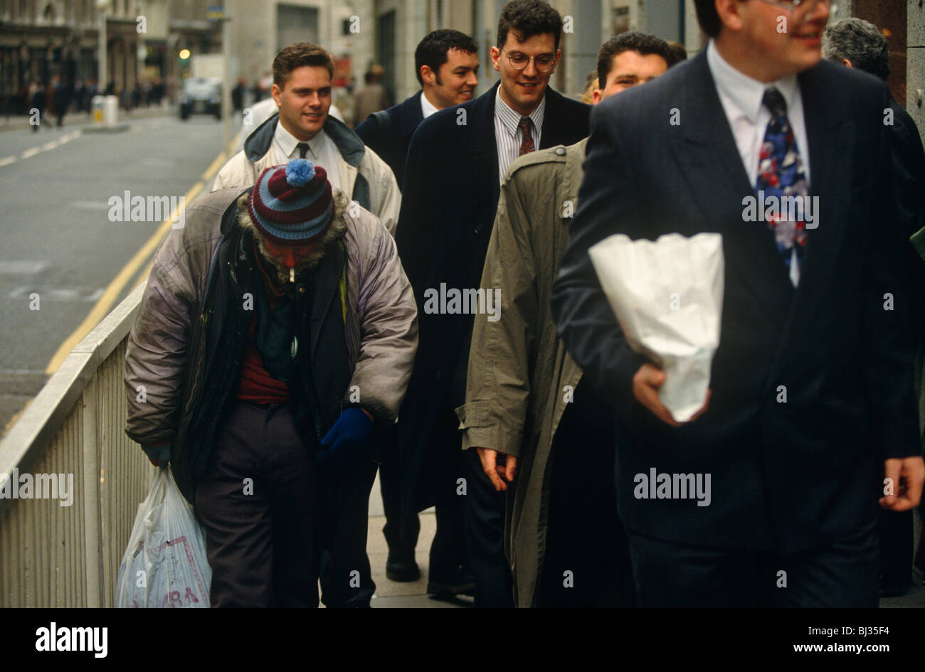 As successful, busy commuters hurry past, a hunched, homeless elderly ...
