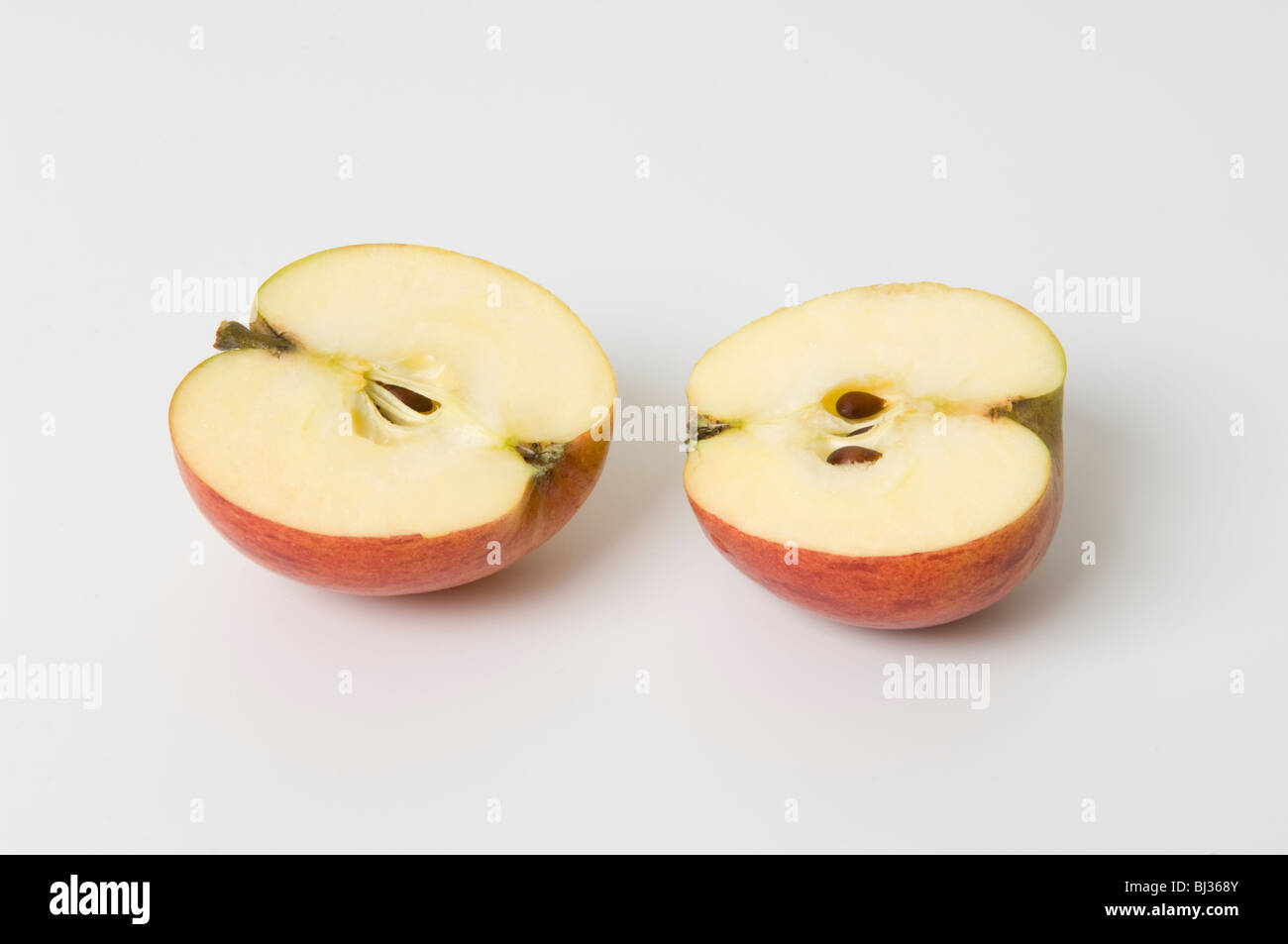 Apple cut into two halves Stock Photo - Alamy