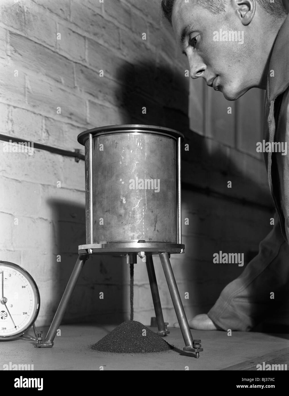 A lab technician undertaking a coal flow test, Mapperley Colliery ...