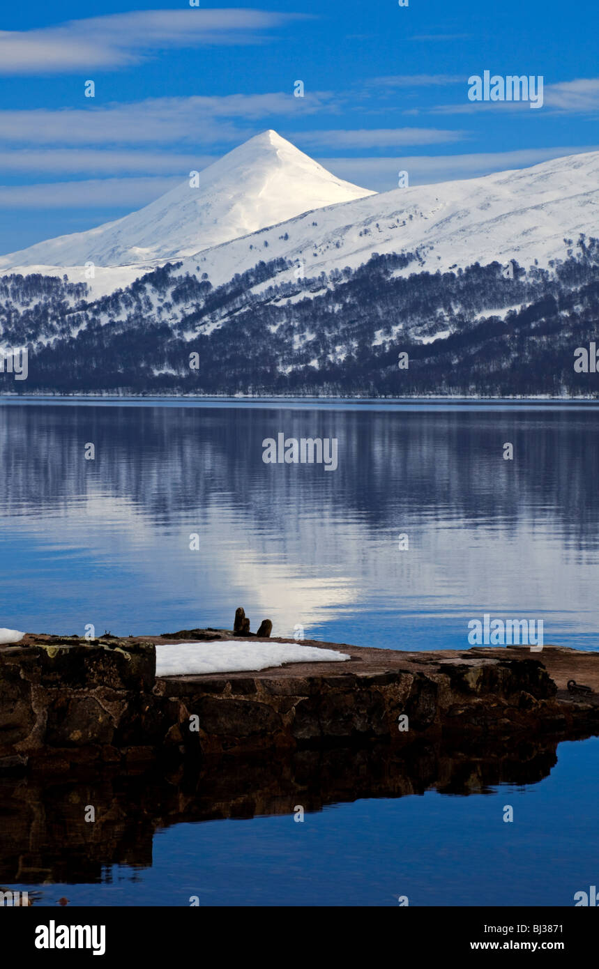 Schiehallion mountain with winter snow capped peaks reflected in Loch ...