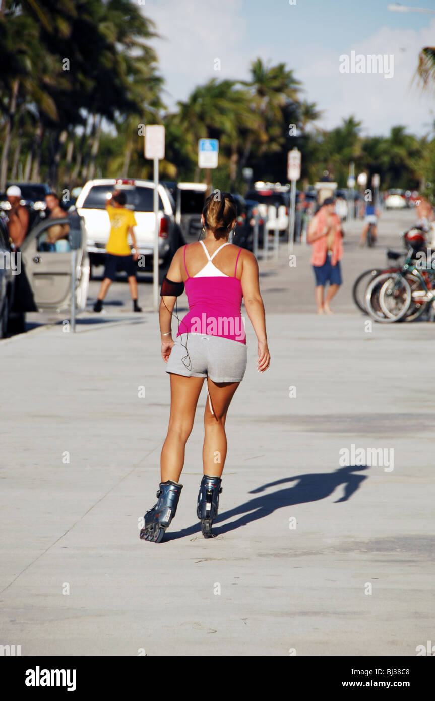 Back view of young fit woman roller blading on street Stock Photo - Alamy