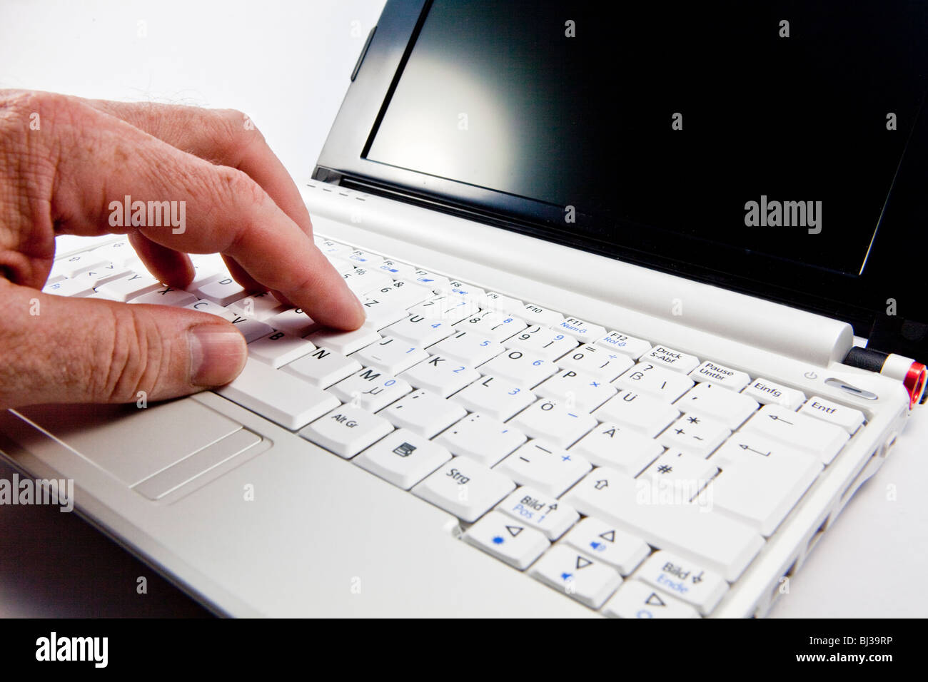 Laptop, netbook, a hand entering data Stock Photo - Alamy Laptop, netbook, a hand entering data Stock Photo - Alamy