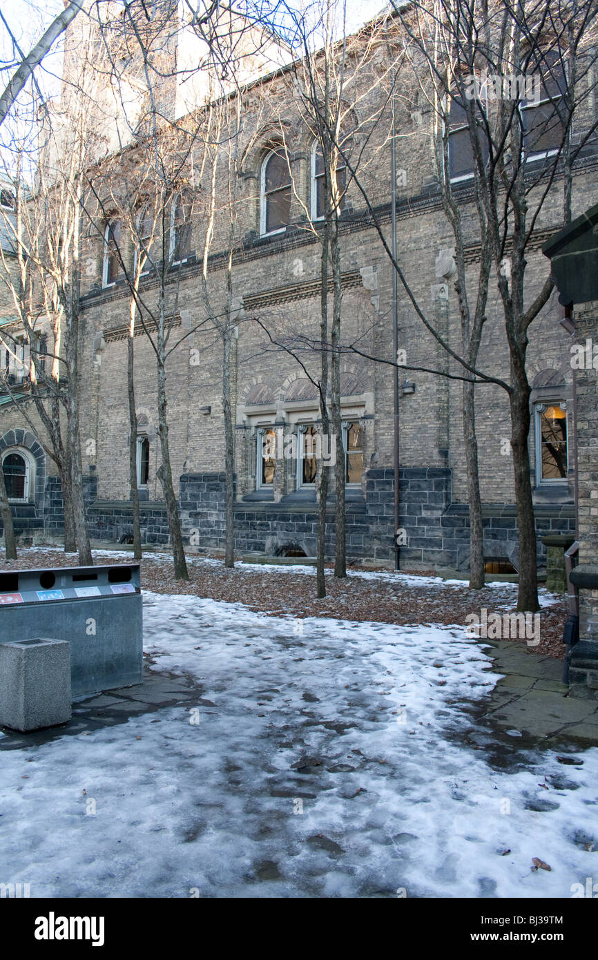 Snow melting in front of an old historic building on a sunny afternoon ...