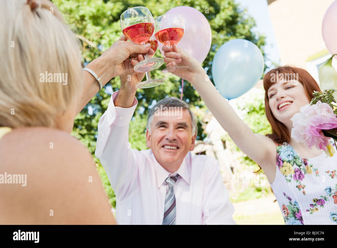 Happy family raising glasses hi-res stock photography and images - Alamy