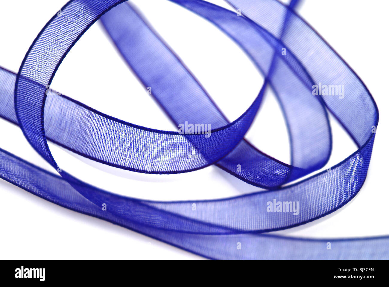 Curly violet ribbon over white background Stock Photo - Alamy