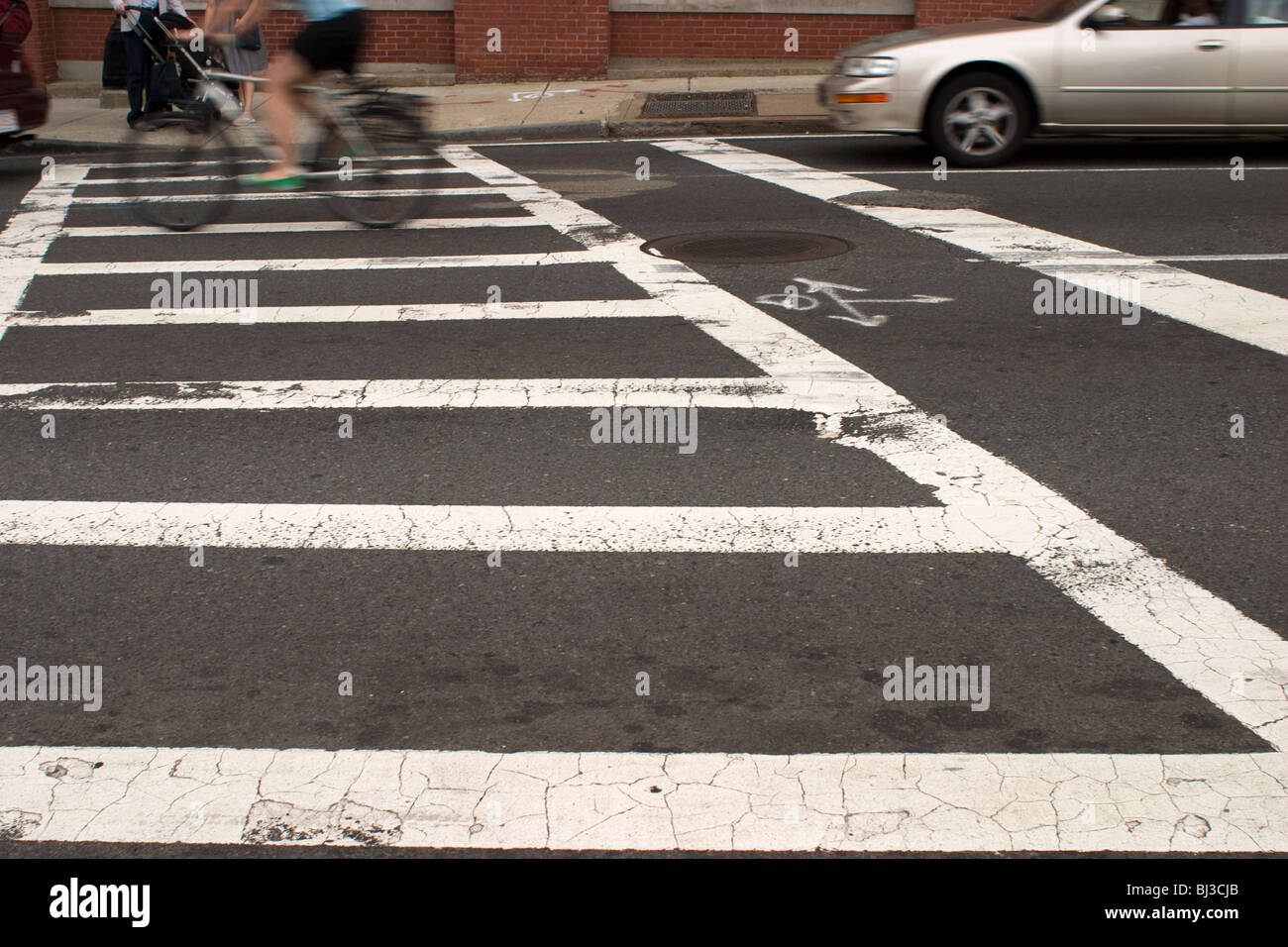 A bicycle whizzes across white lines the indicate a path for ...