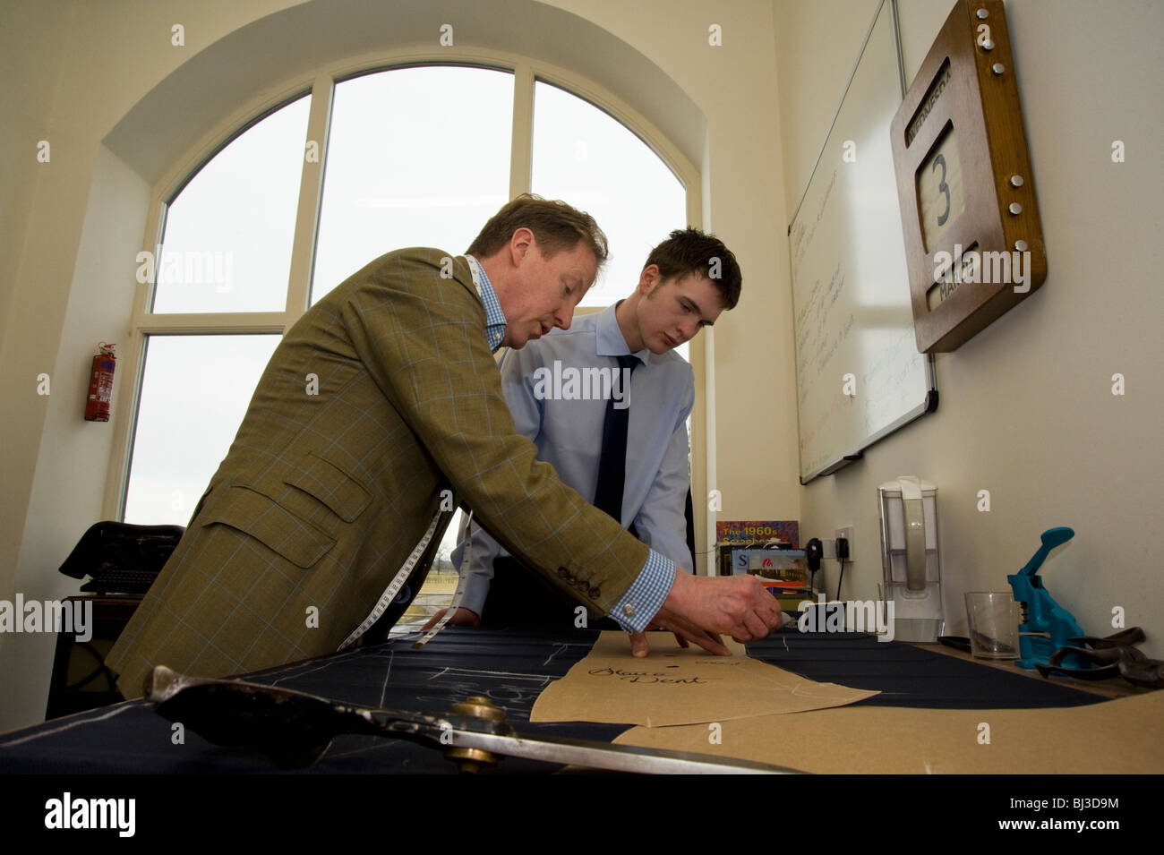 Master tailor Thomas Mahon instructing his new apprentice the trade of ...