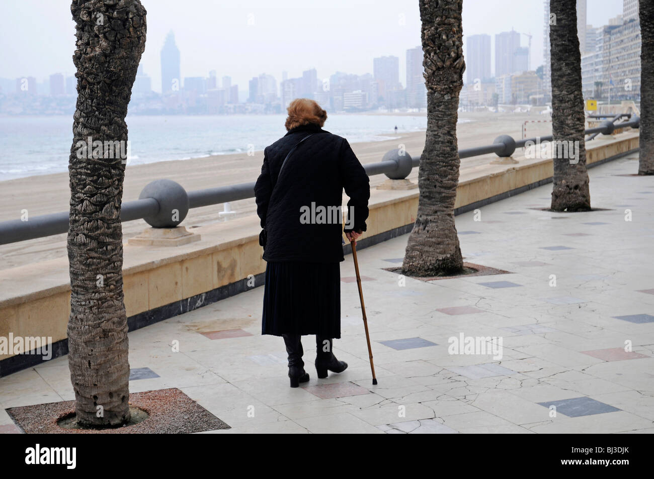 Old woman, cane, promenade, fog, cloudy, grey, bad weather, lonely, sad ...