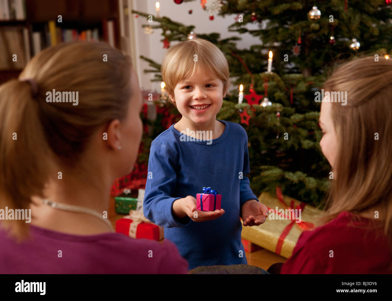 boy showing small christmas present Stock Photo - Alamy