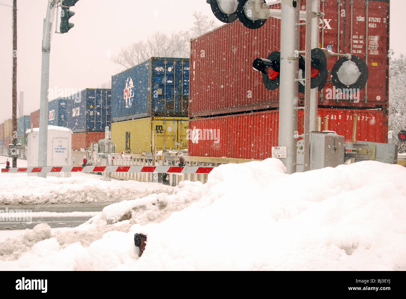 Freight train passes railroad crossing intersection. Barrier and ...