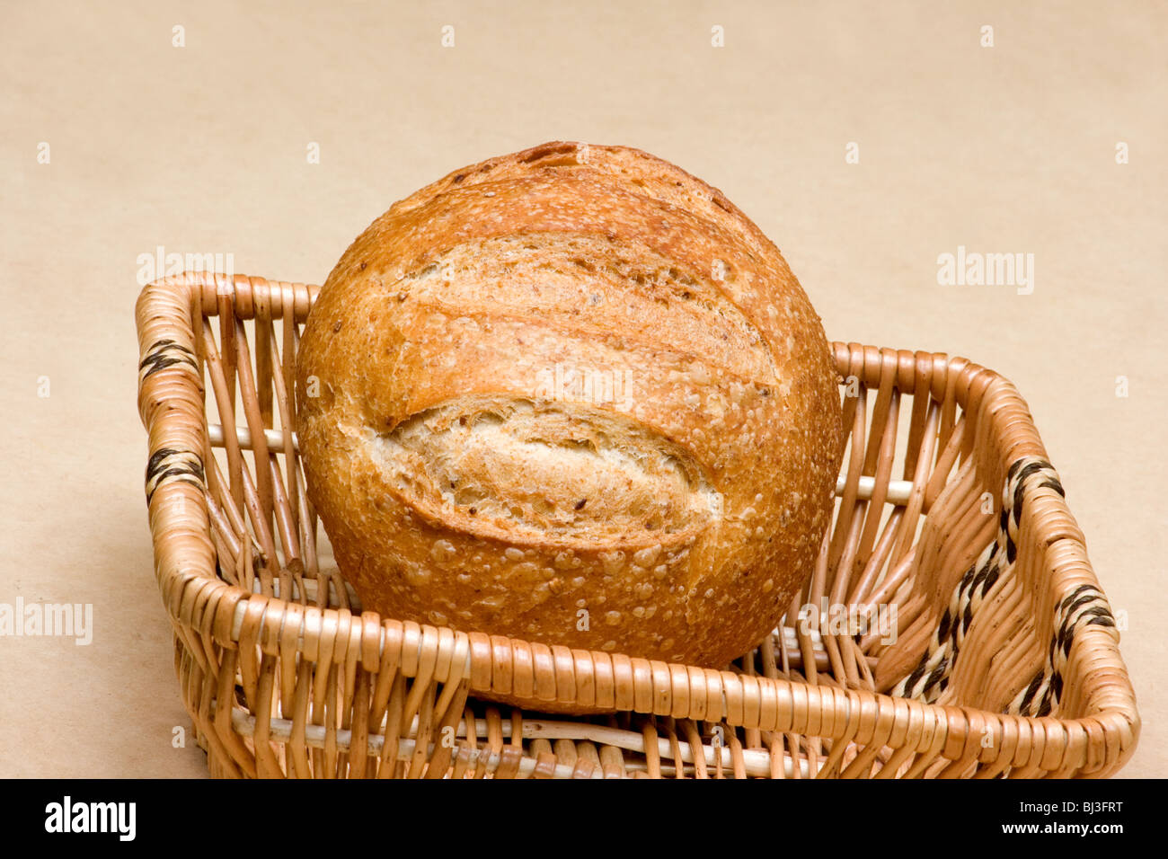 Bread in a basket on neutral background Stock Photo - Alamy