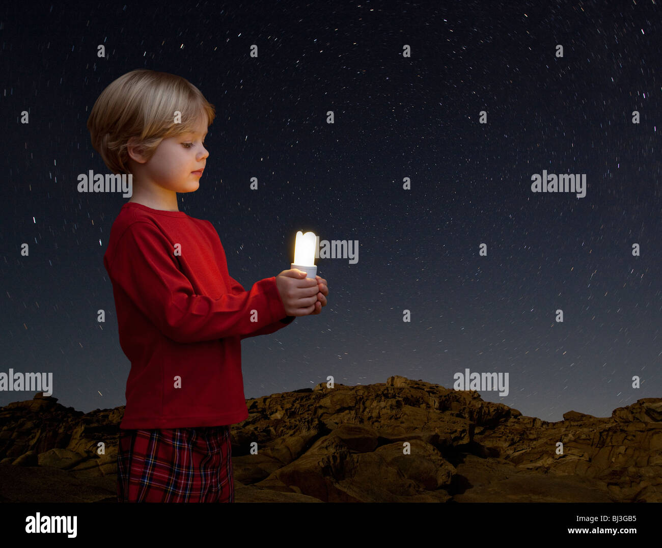boy with energy saving light bulb Stock Photo - Alamy