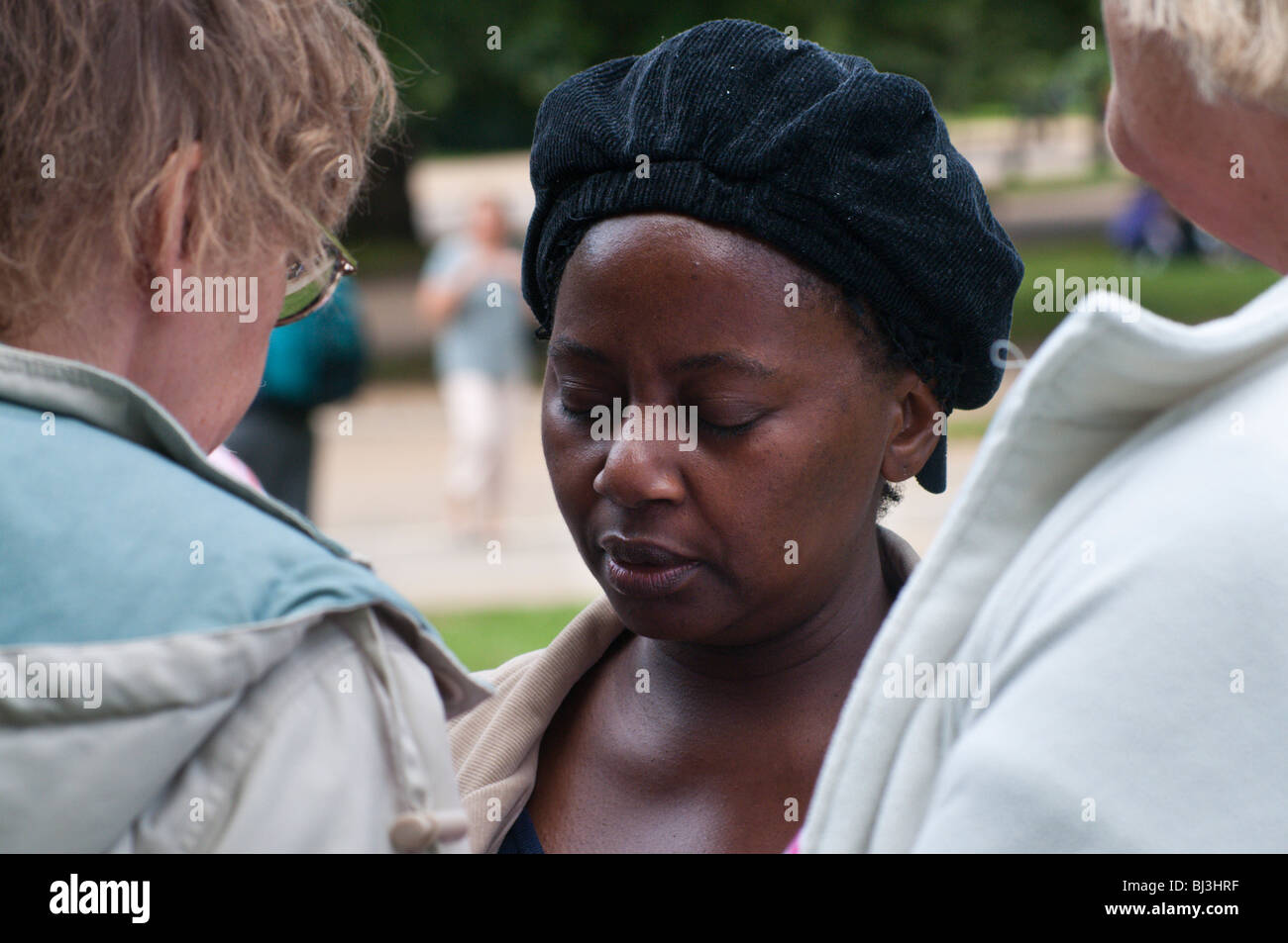 Black woman at prayer in Hyde Park before March of Repentance, London ...