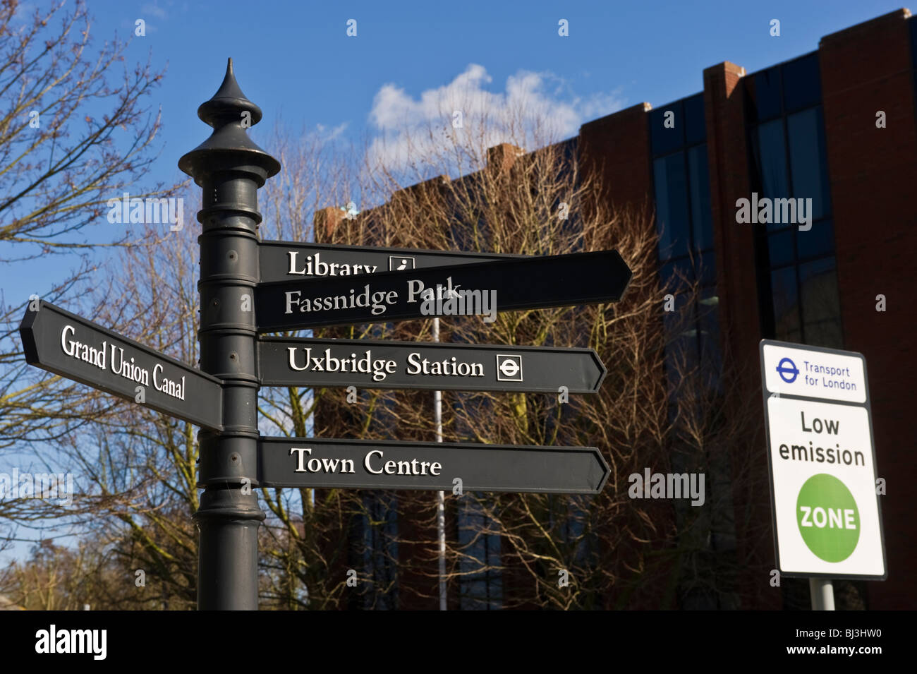 Signpost giving directions and a low emission zone sign in Uxbridge ...
