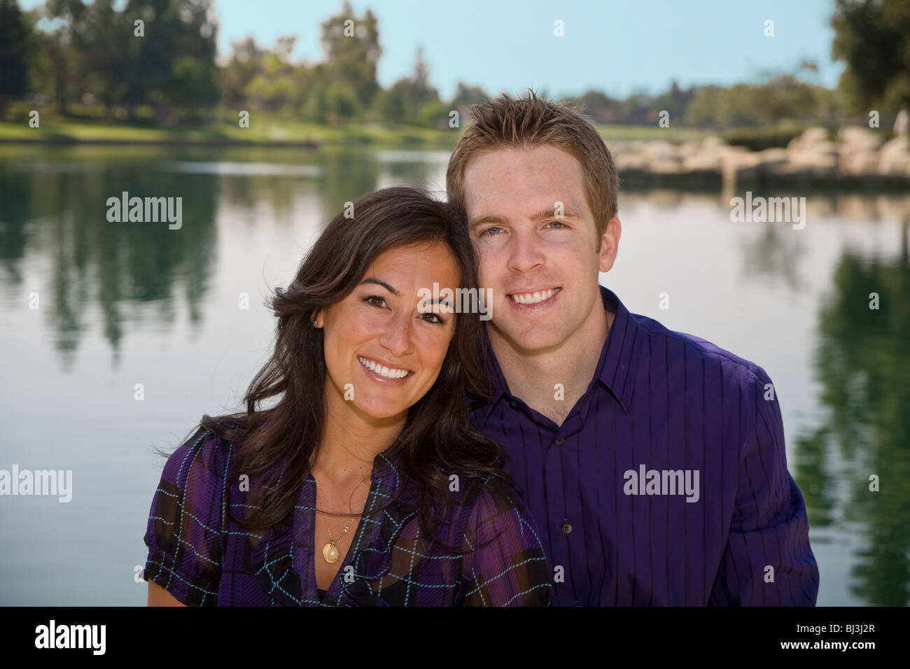Close up portrait Young couple cheeks cheek together lakeside park ...