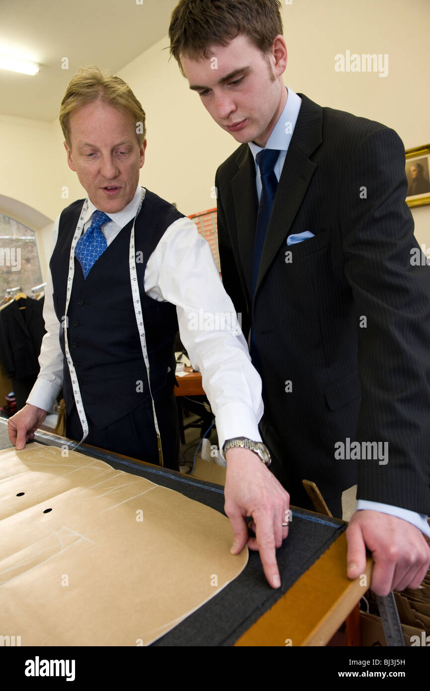 Master tailor Thomas Mahon instructing his new apprentice the trade of ...