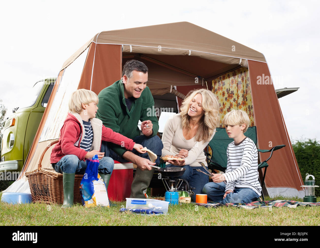 Family cooking together outdoors Stock Photo - Alamy