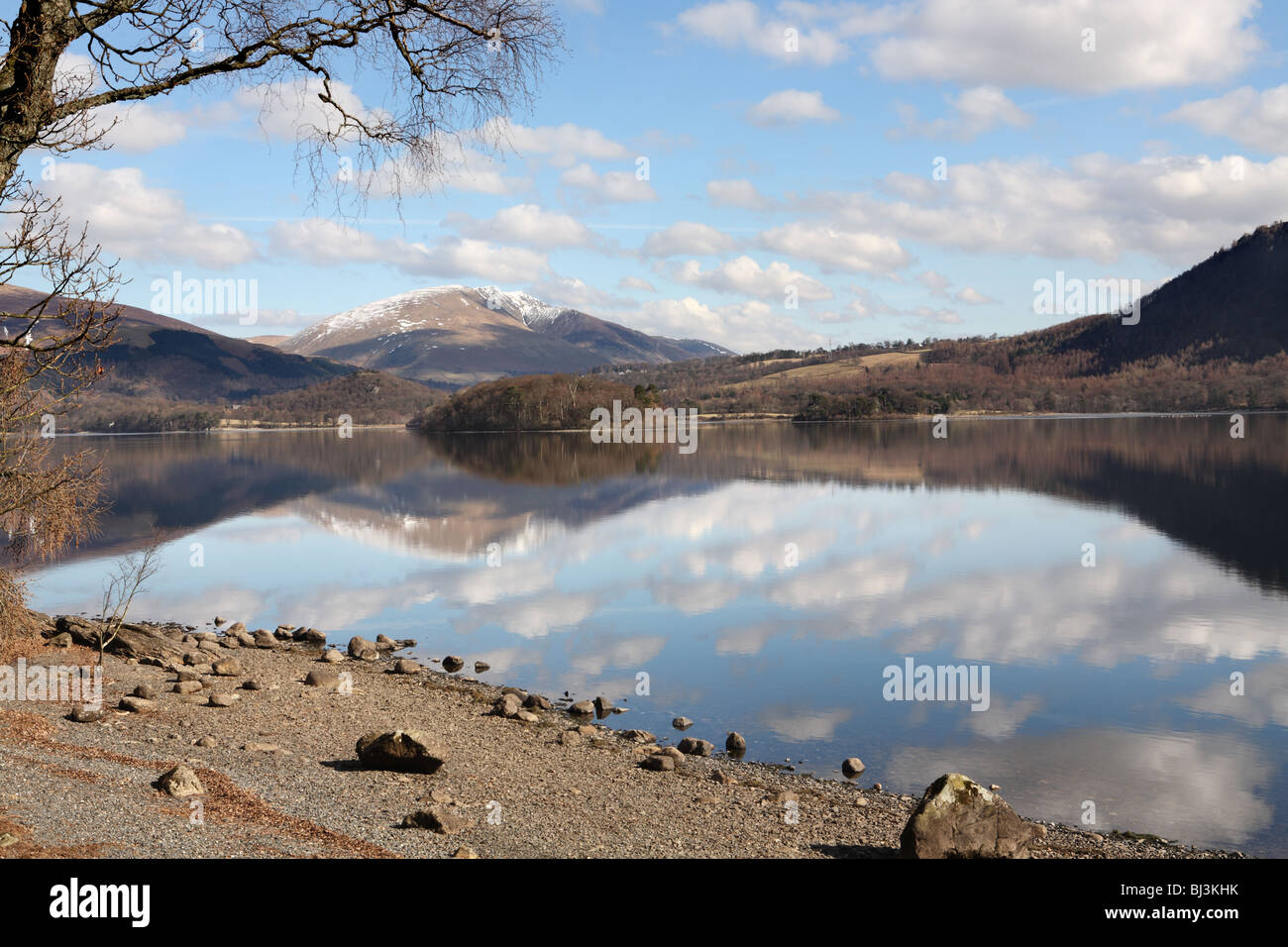 A view across Derwent water with clouds reflected in the lake with ...