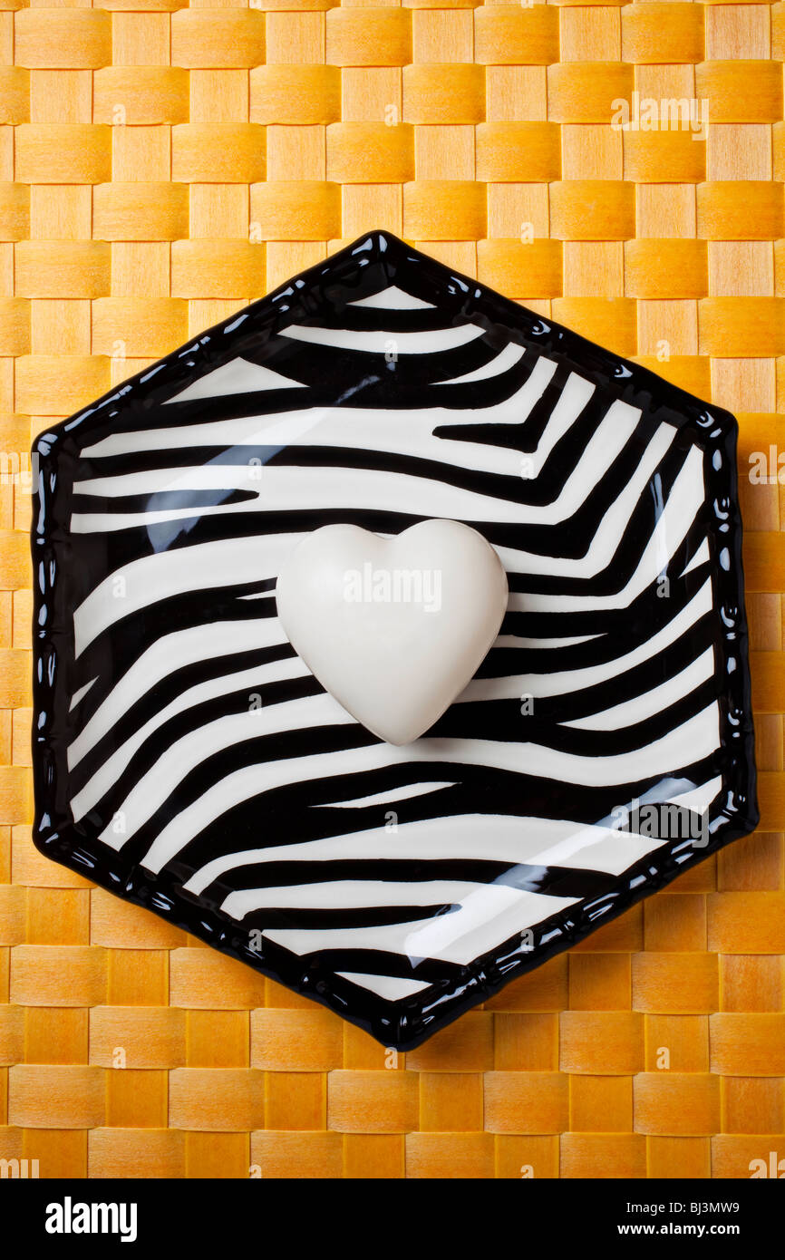White heart shaped bar of soap on striped plate Stock Photo - Alamy